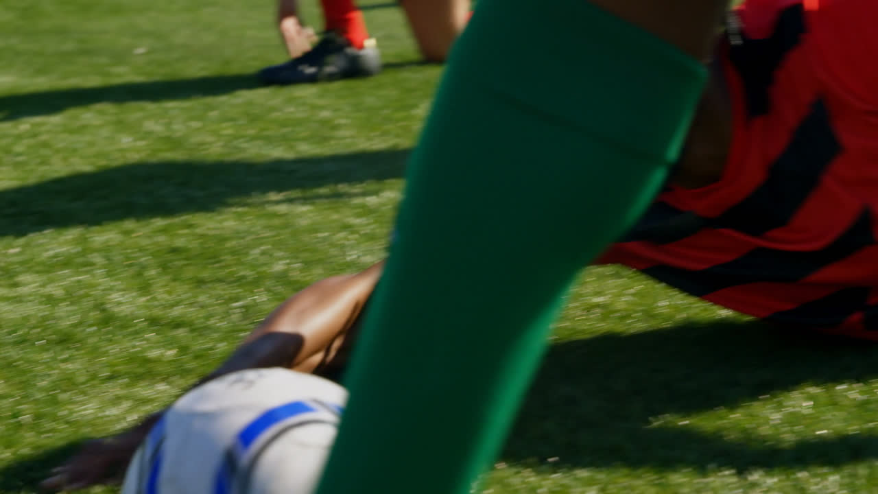 Premium stock video - Football players practicing on the field 4k