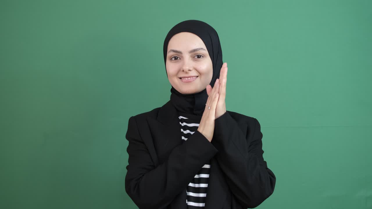 Premium stock video - Hijabi girl sign hand