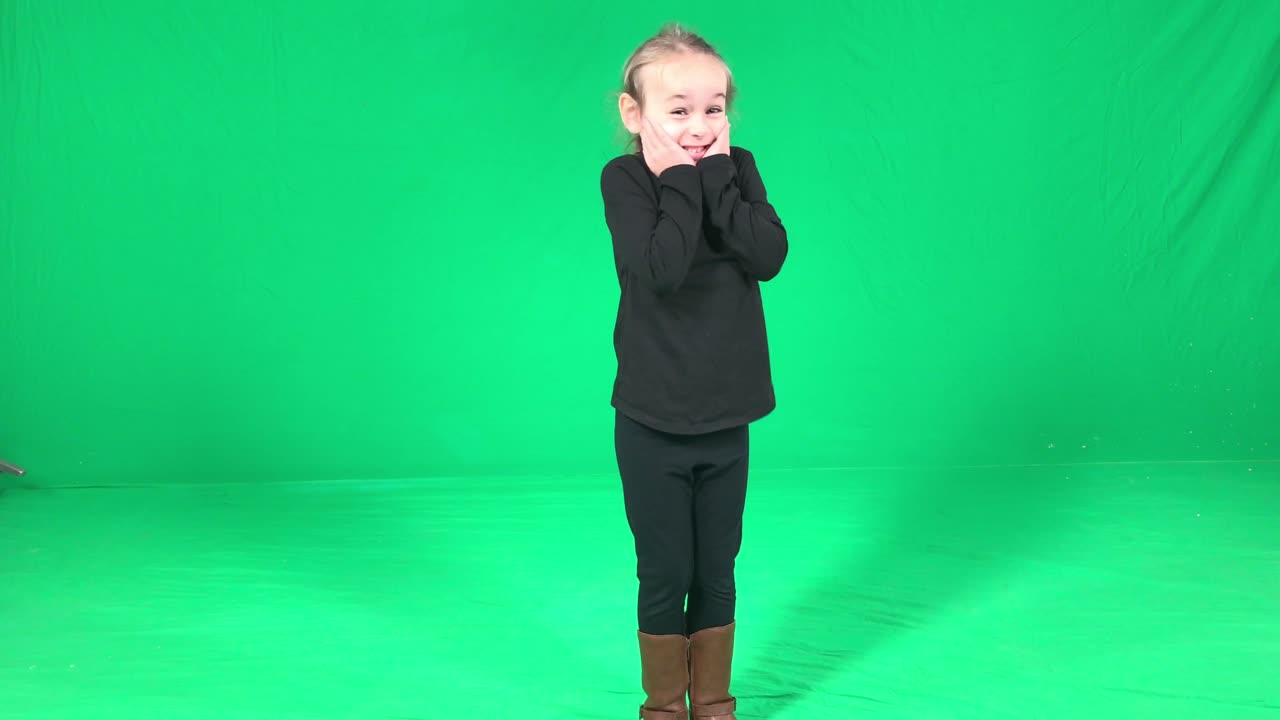 Premium stock video - Excited little girl squirms with delight