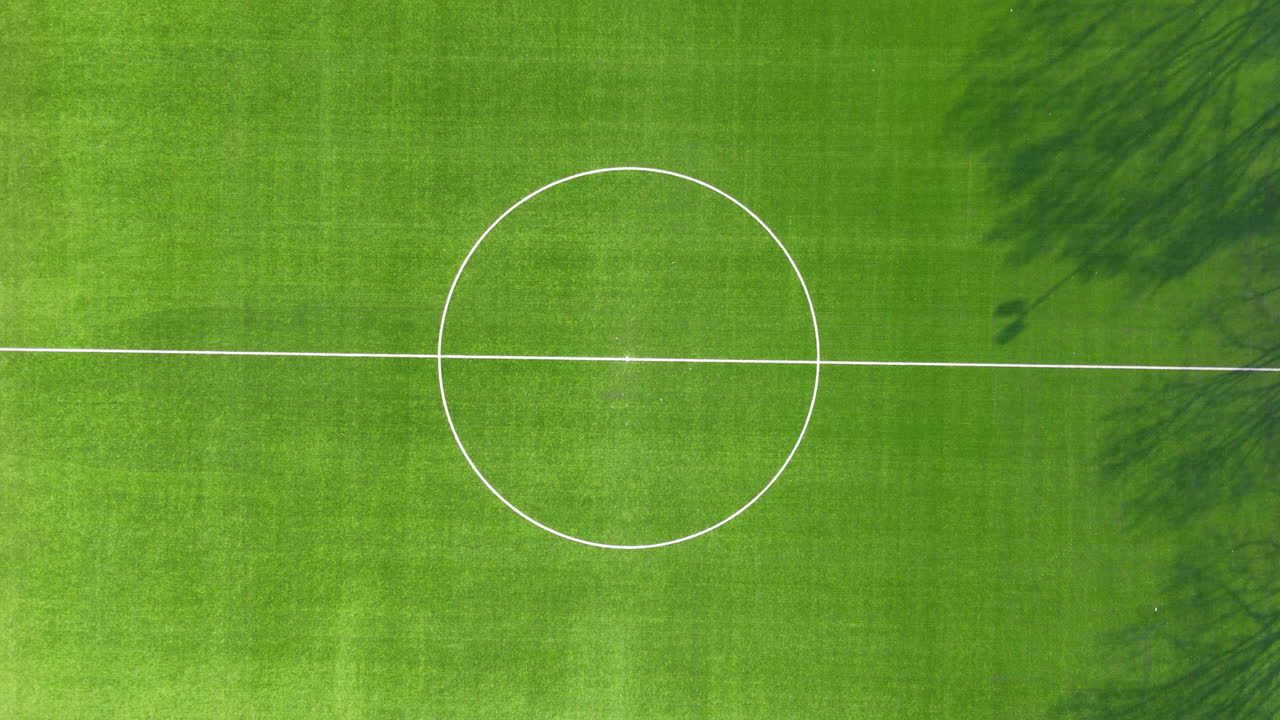 High top down view of center spot on soccer field - slowly zooming out ...