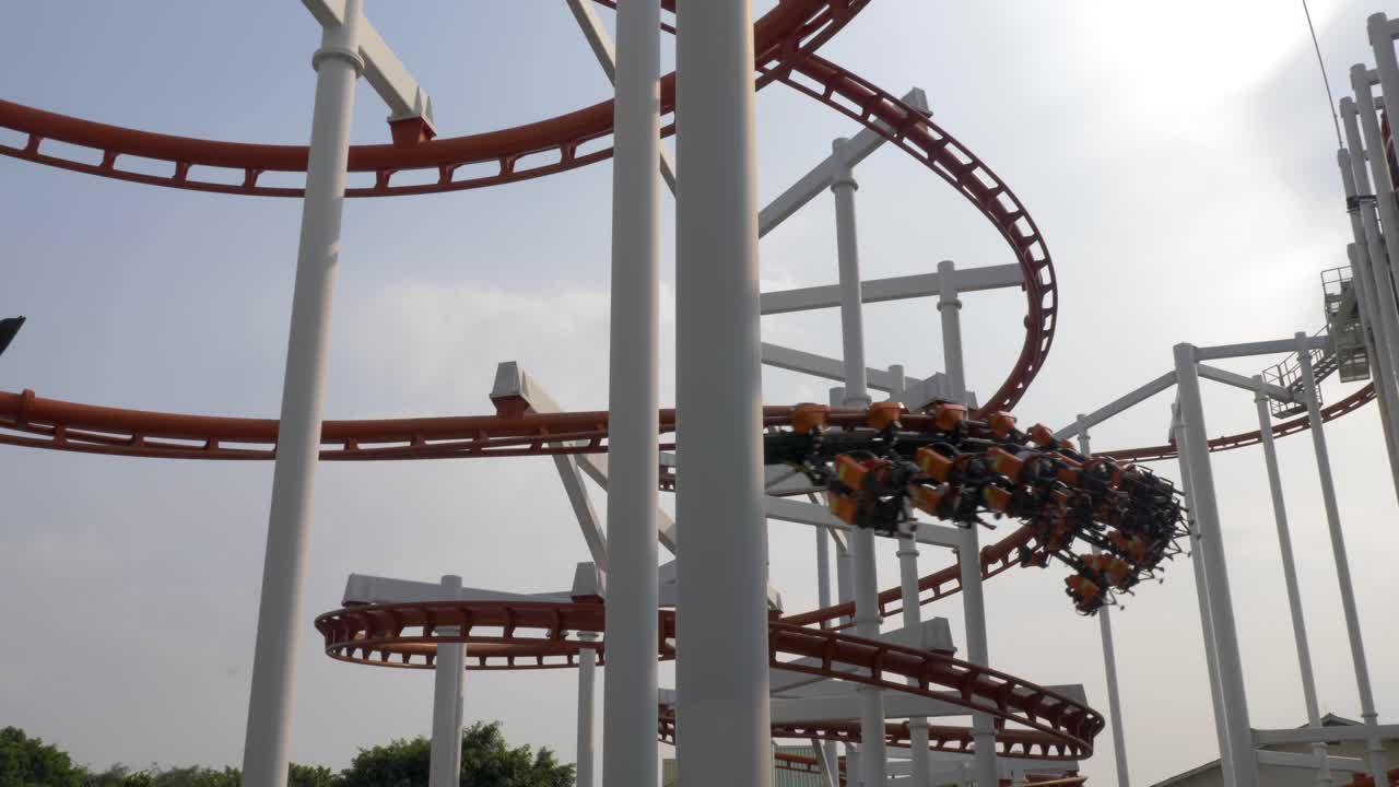 Slowmo: Roller coaster train going down in a spiral on the roller ...