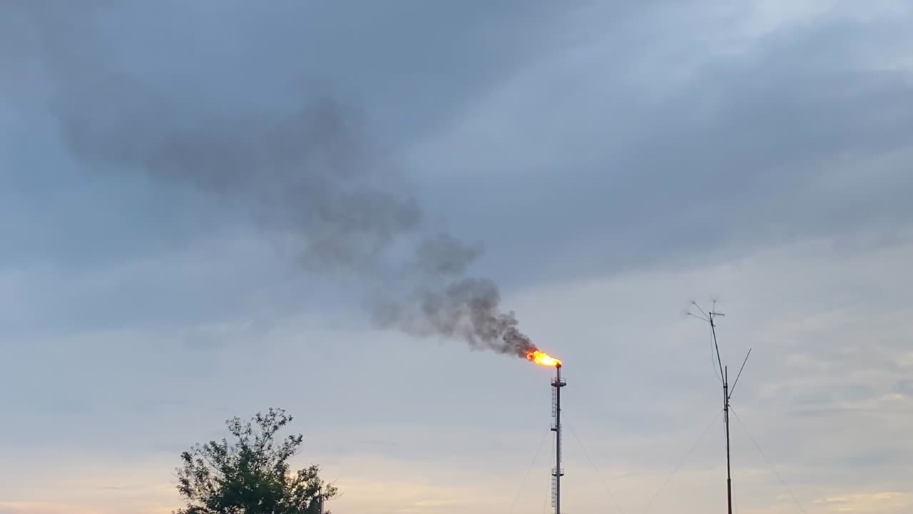 Fire Flaming With Smoke Through Gas Pipe At A Gas Field Against Sky At ...