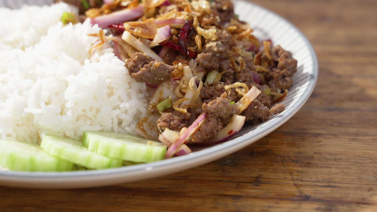 Premium stock video - National dish of laos beef larb plated with sticky white rice, slider ...