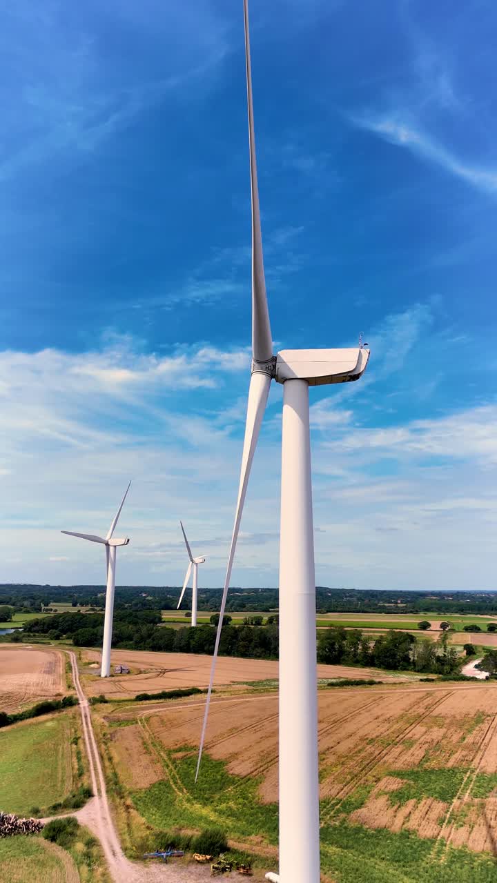 Premium stock video - Onshore wind farm 4k vertical drone video