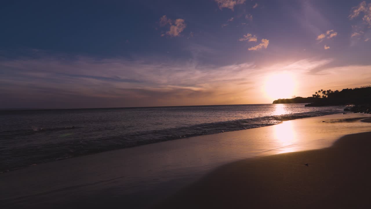Premium stock video - Person freestyle swimming across a secluded beach ...