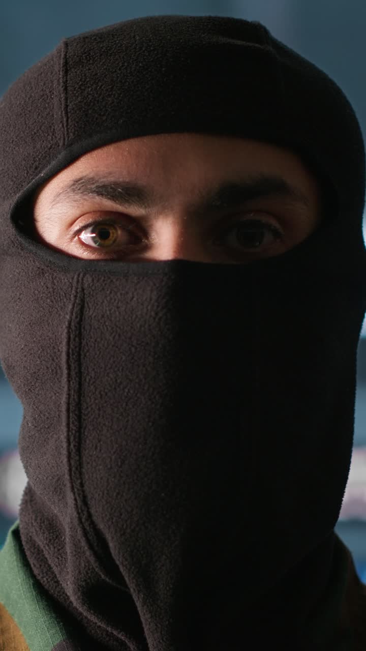 Vertical video Portrait of terrorist loading gun, attacking enemy ...
