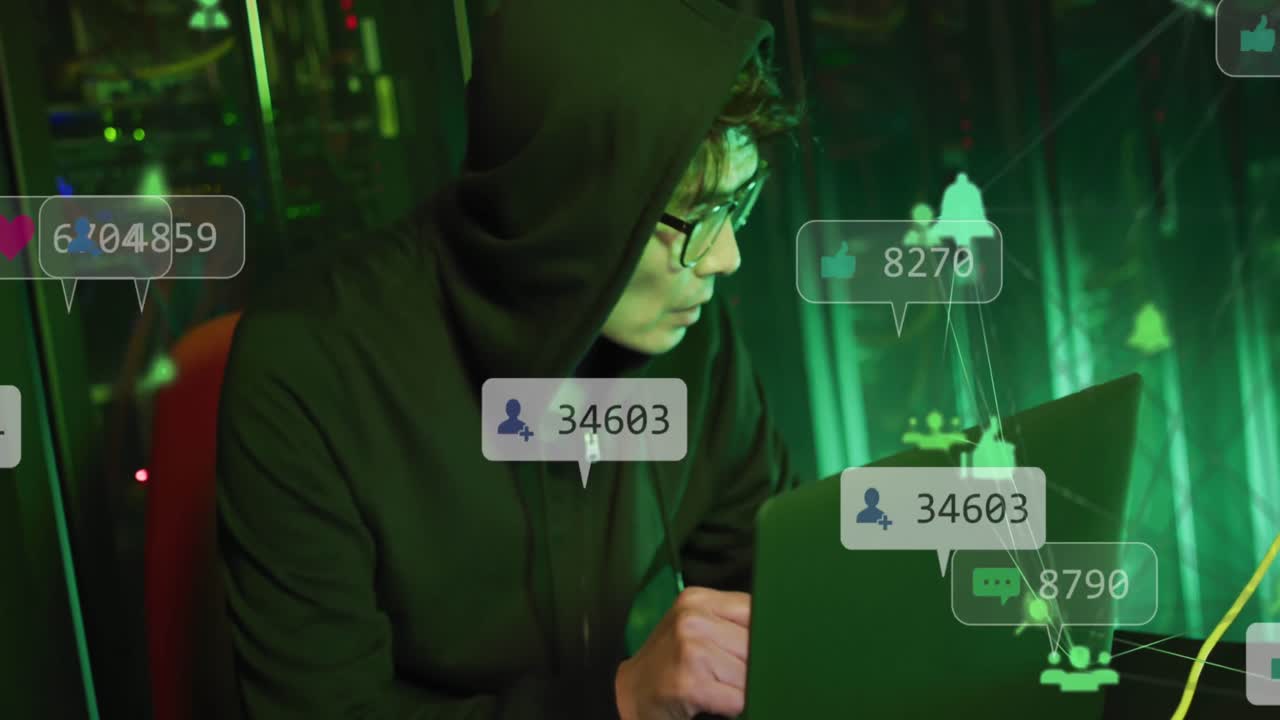 Animation Of Social Media Icons Over Asian Male Hacker Using Laptop At ...