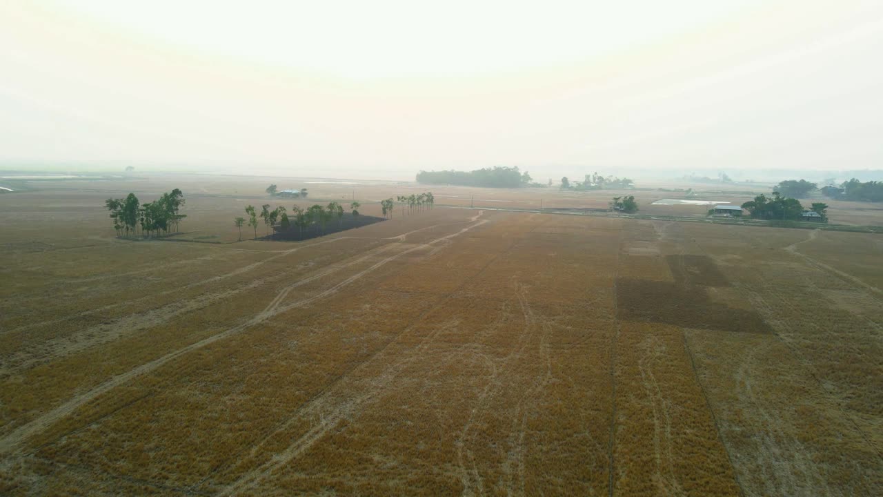 Drone captures aerial view of dry farm land Premium Stock Video Footage