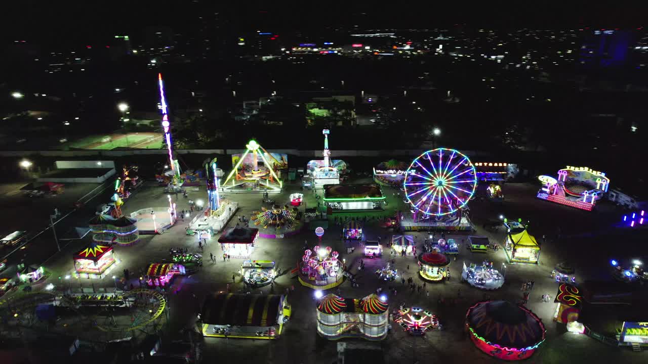 Premium stock video - Overflying a mexican fair at night