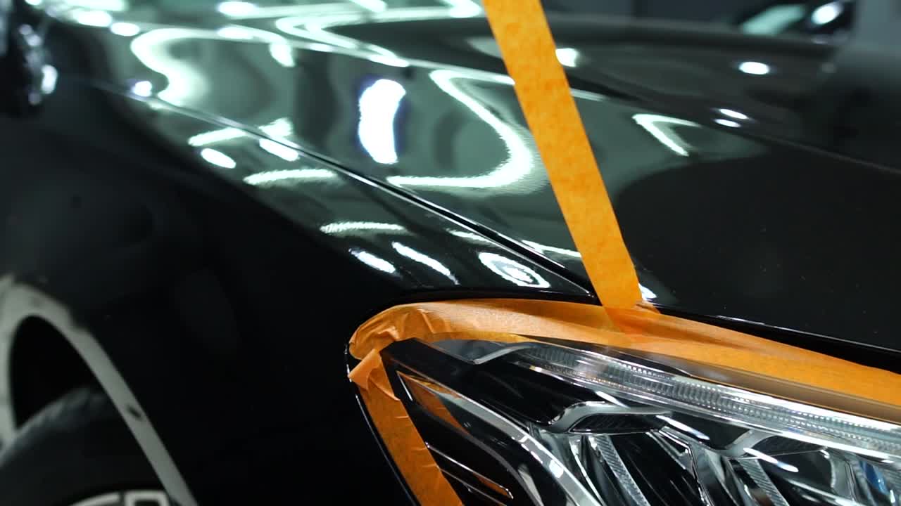Premium stock video - Removing exterior taping after car buffing and ...
