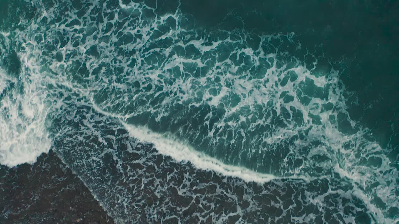 Premium stock video - Waves crashing over the beach during sunset