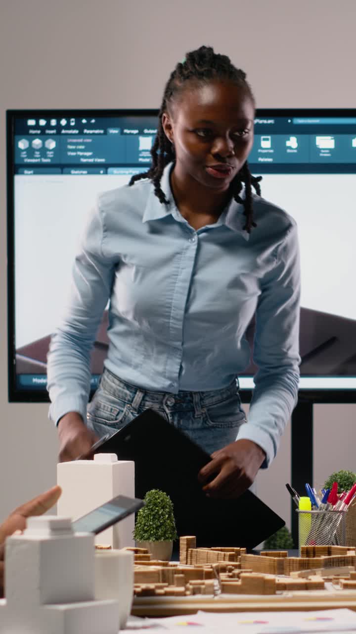 Vertical Video Multiethnic architecture developers using 3D models in ...