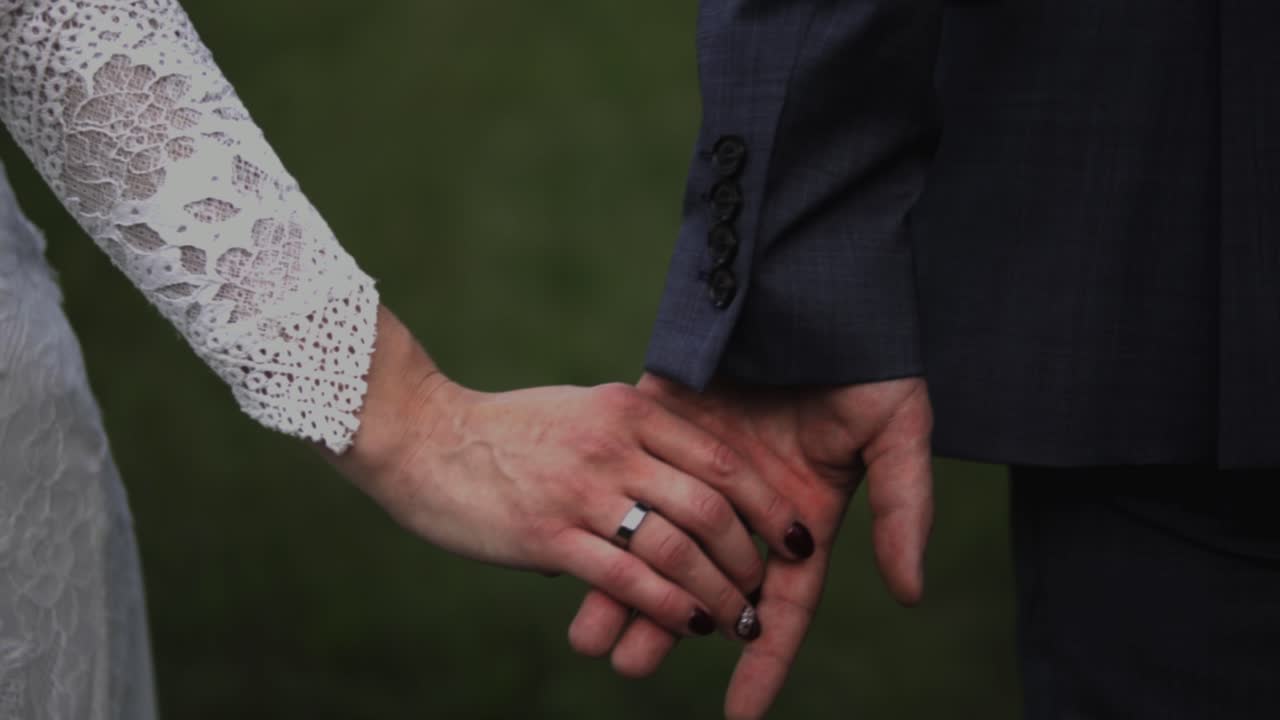 Wedding couple holding hands in slow motion Premium Stock Video Footage