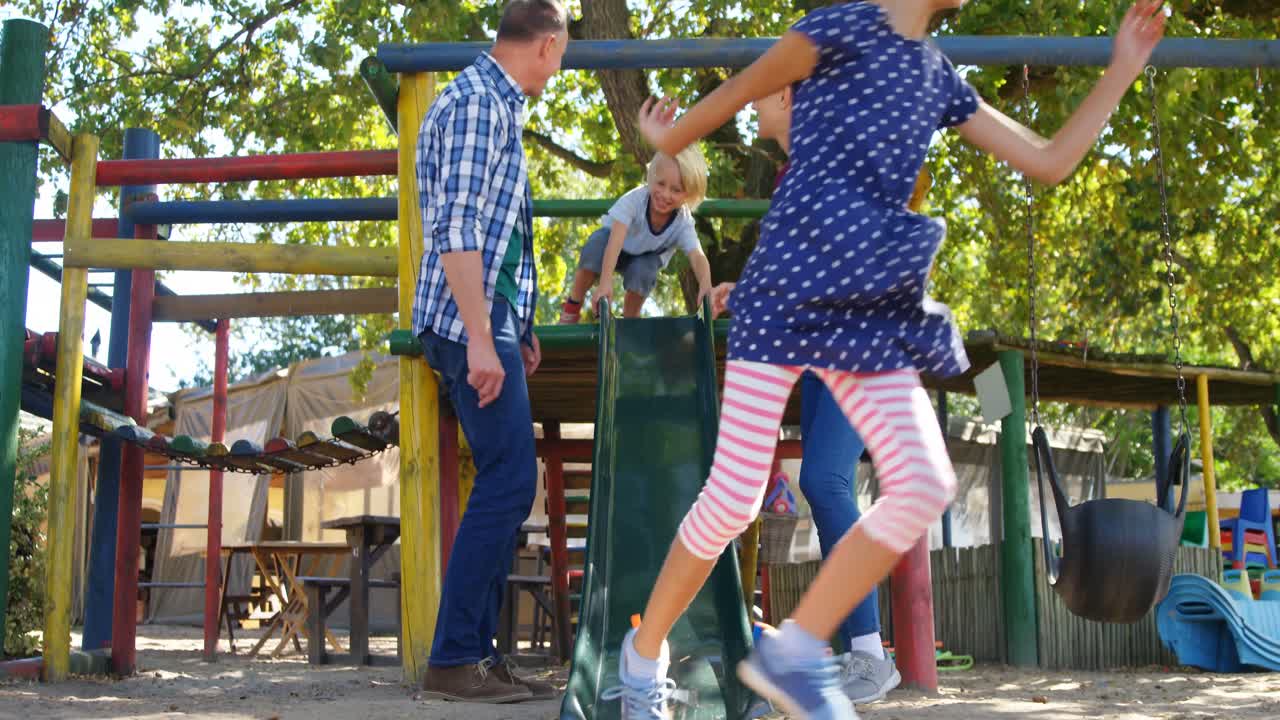 Premium stock video - Family playing in the playground 4k