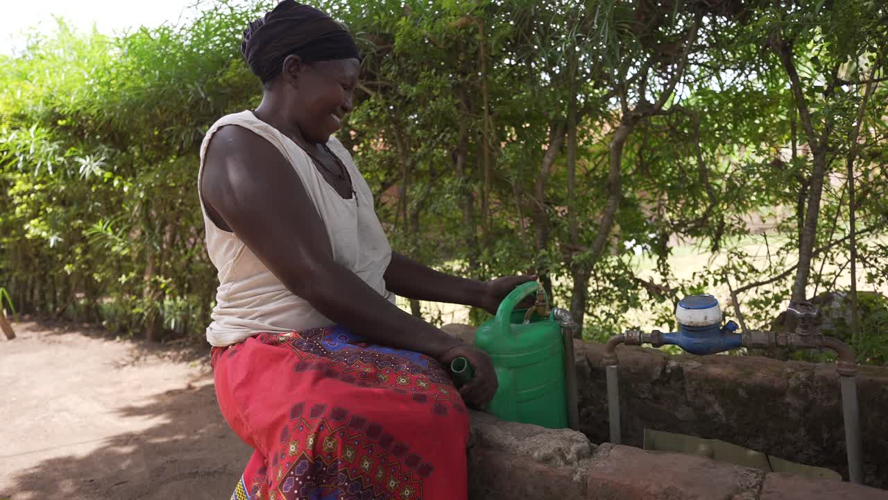 Premium stock video - Local african woman doing housework and smiling ...