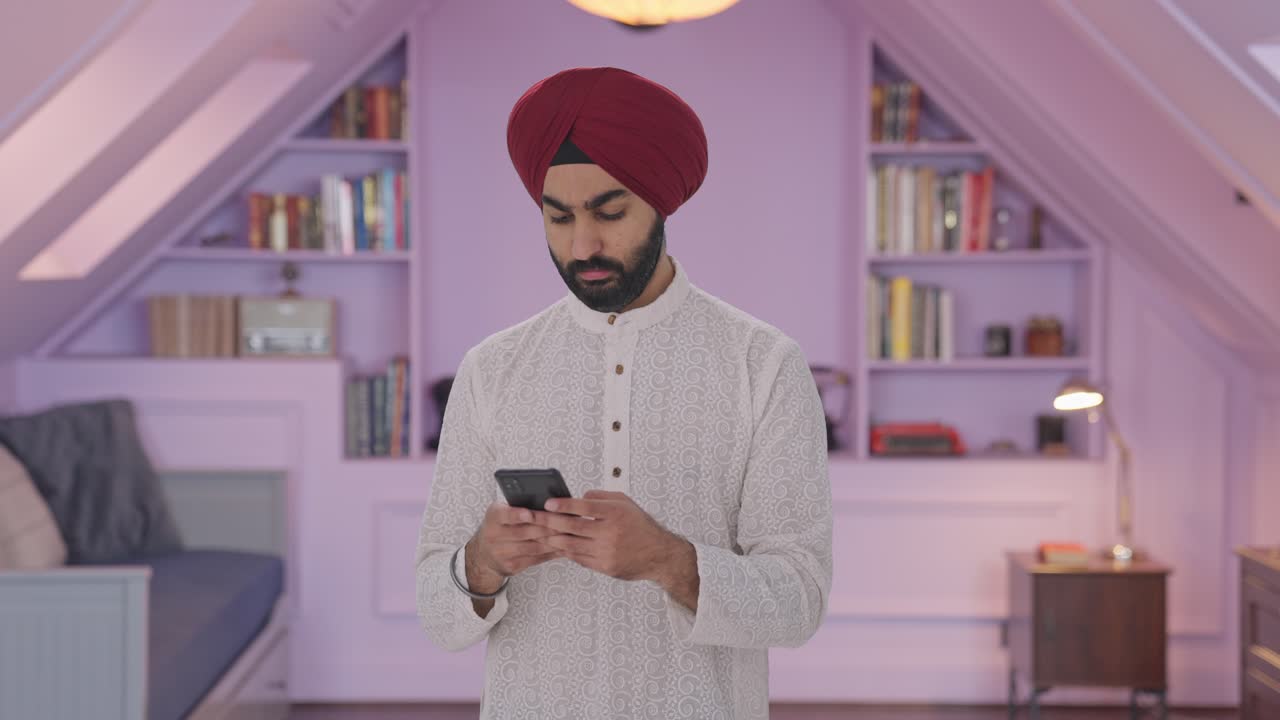 Premium stock video - Sikh indian man texting someone