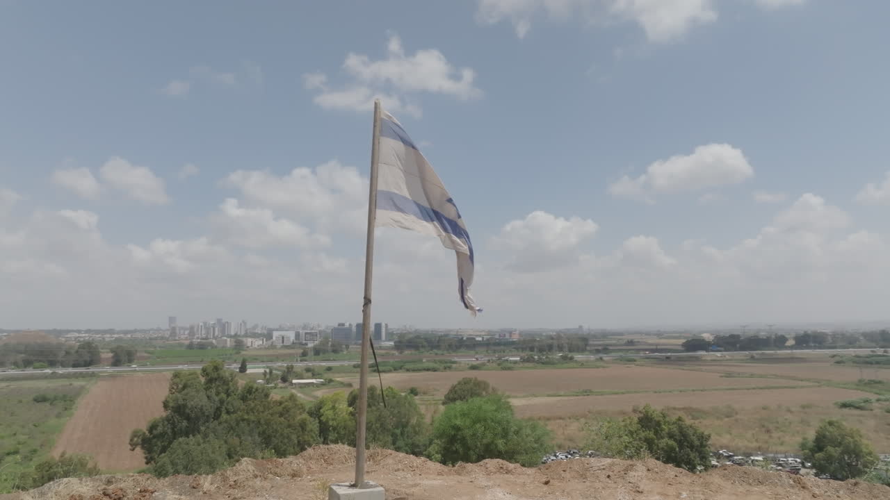 Premium stock video - An israeli flag on a mountain in the center of ...
