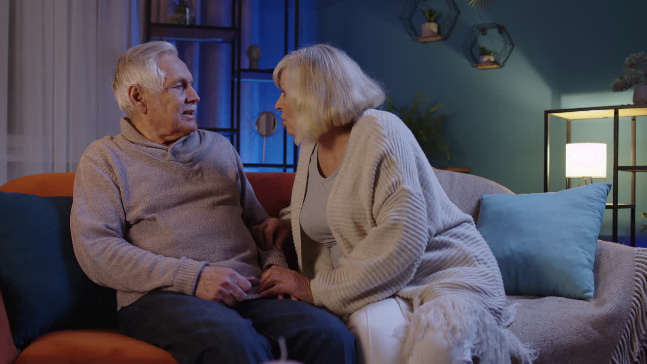 Portrait of angry mature grandparents couple quarreling in evening at ...