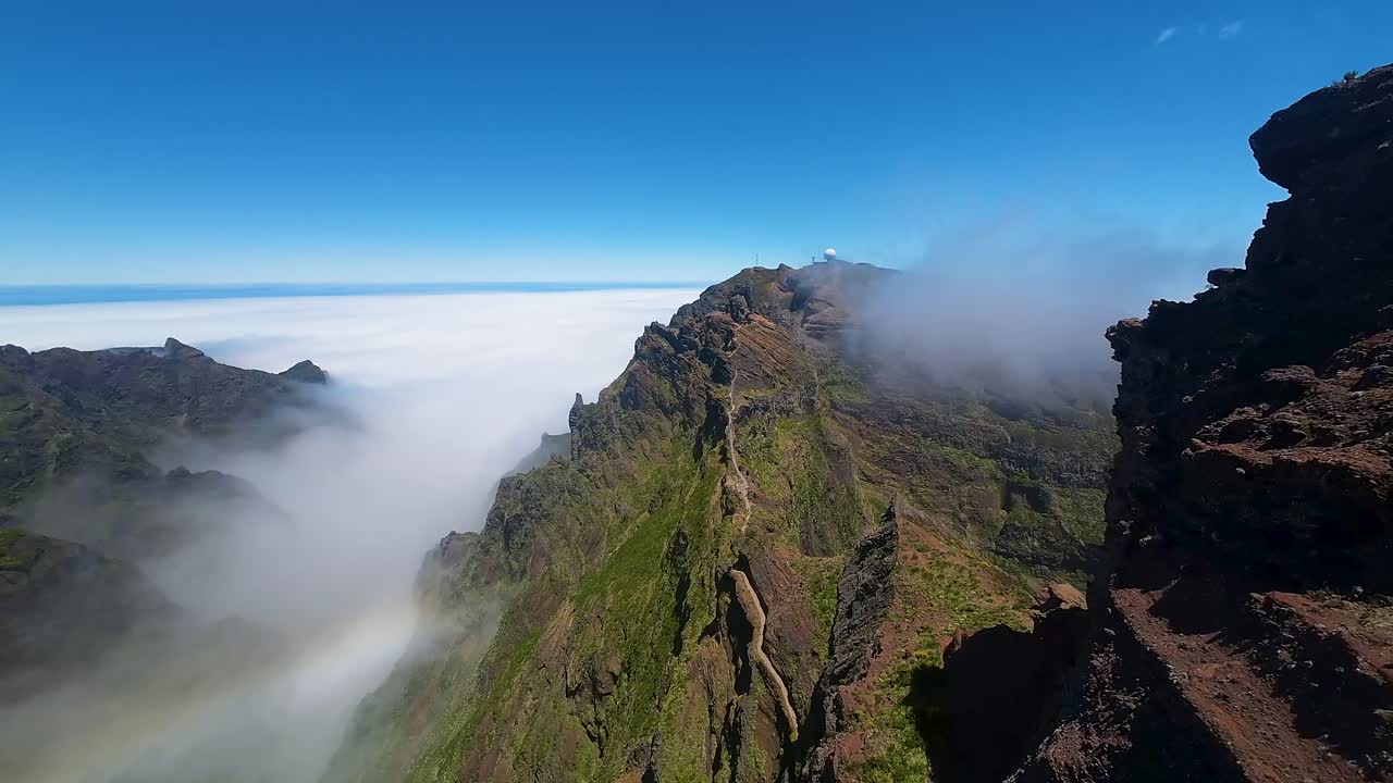 Premium stock video - Pico do pico trail on top of ridge with steep cliffs