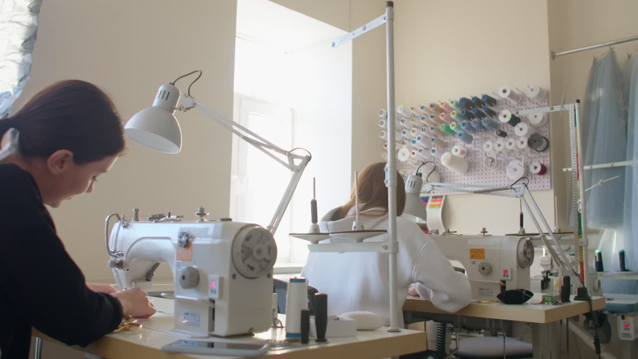 Premium stock video - Two women seamstresses working on sewing machines ...