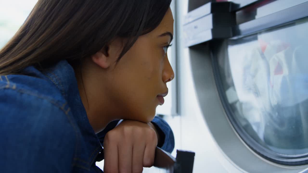 Woman looking at washing machine at laundromat 4k | Premium Stock Video ...