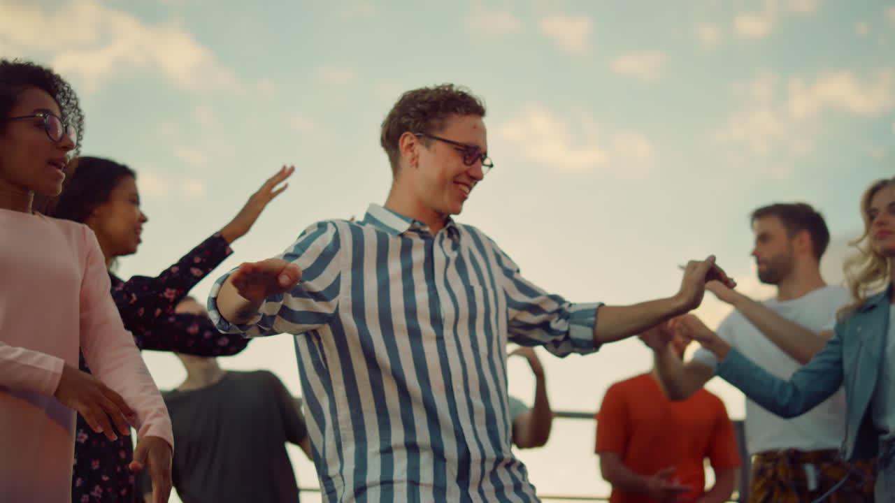 Happy guy having fun with friends at party. Partying people dancing ...