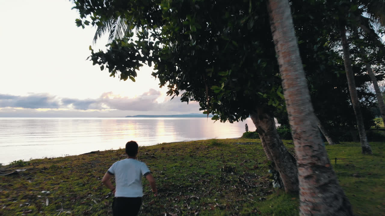 A man running through the trees into river Premium Stock Video Footage
