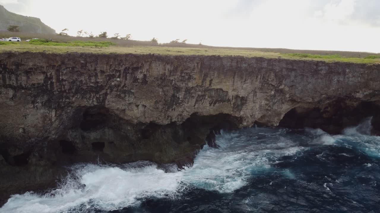 Waves crashing on cliffs at banzai cliff, saipan, northern mariana ...