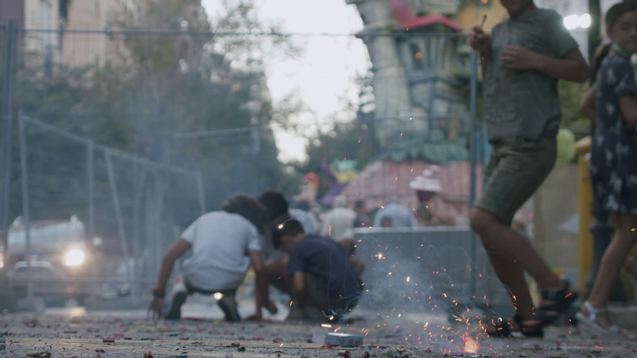 Children throw firecrackers on the streets | Premium Stock Video Footage