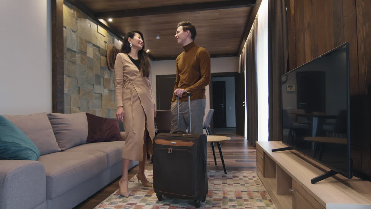 Couple checking in to a modern hotel room Premium Stock Video Footage