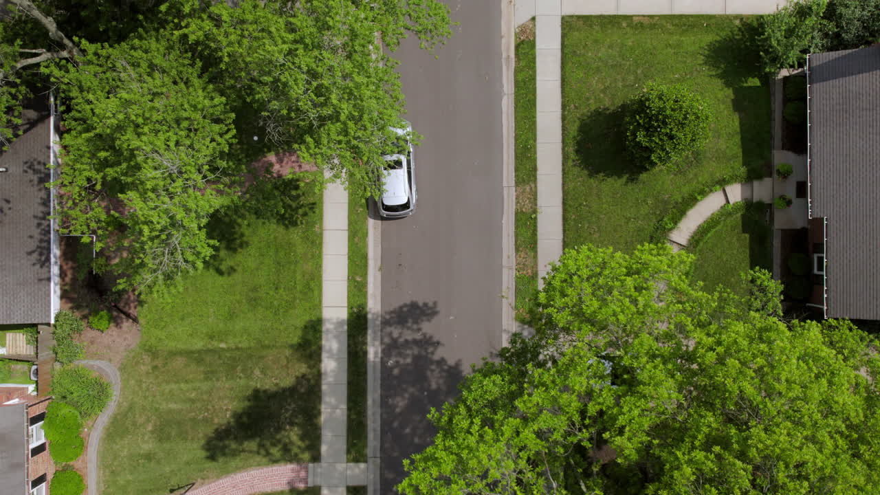 Premium stock video - Overhead of a white car pulling out of a driveway ...