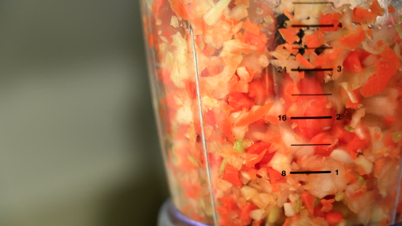 Food processor is mixing vegetables at high speed | Premium Stock Video ...
