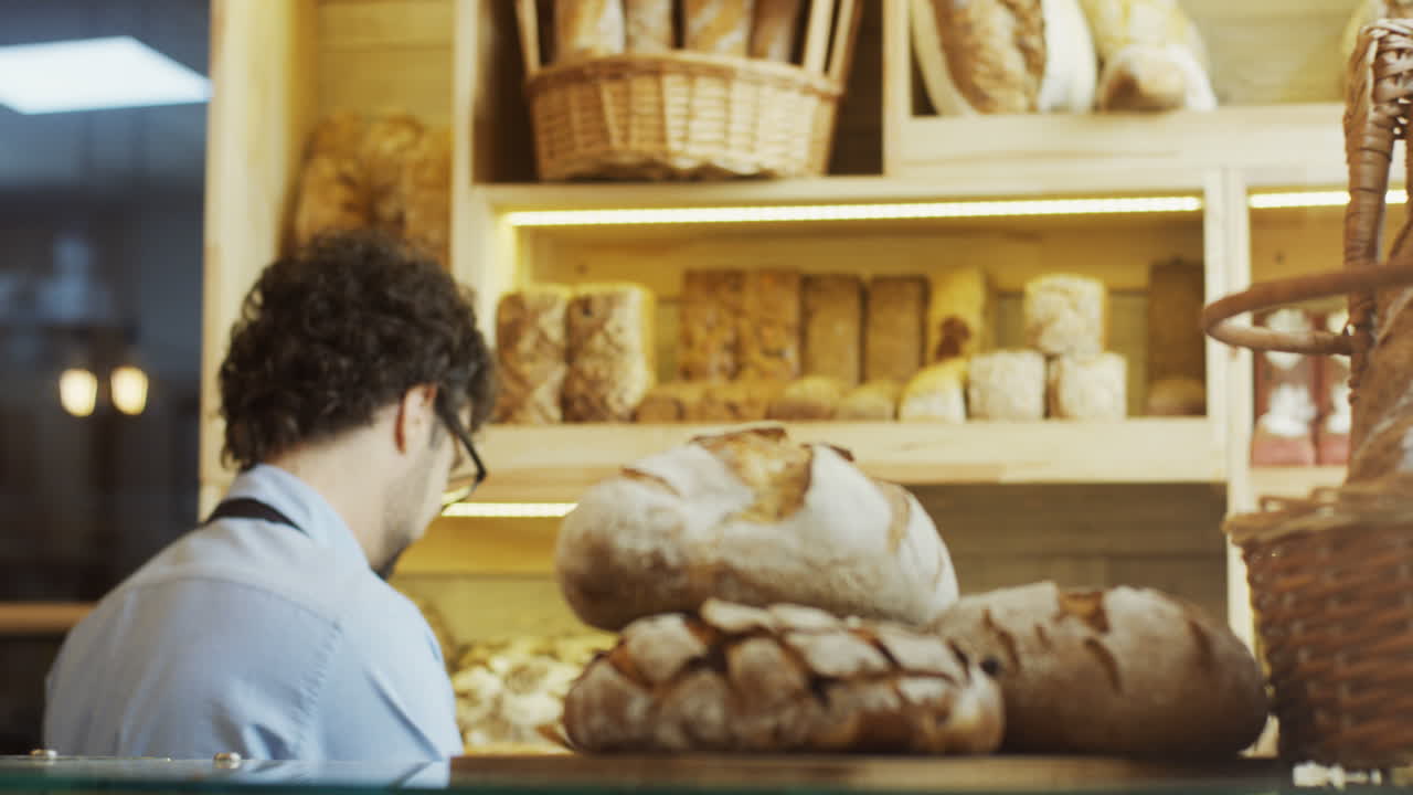 Free stock video - Portrait shot of the handsome male bakery vendor in ...