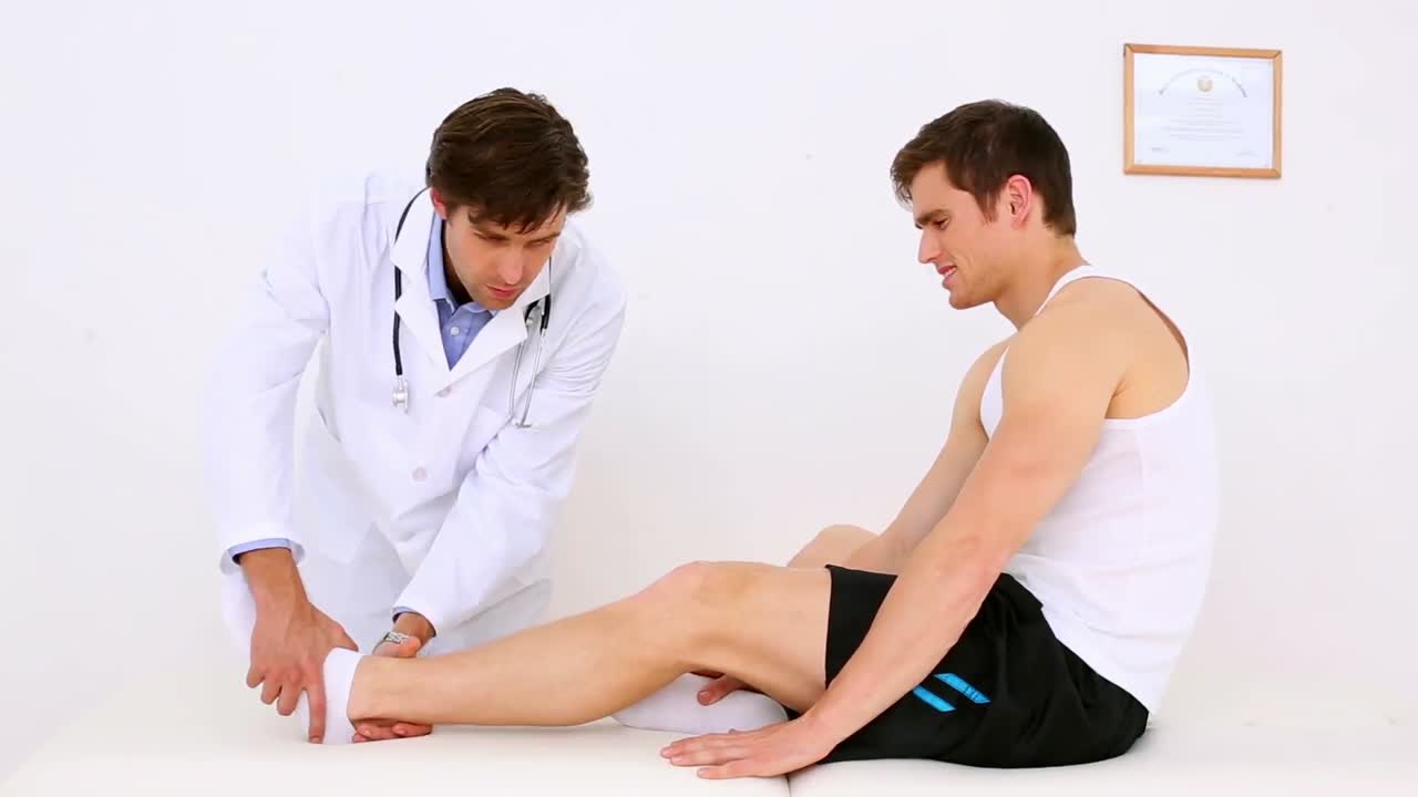 Doctor checking patients injured ankle Premium Stock Video Footage