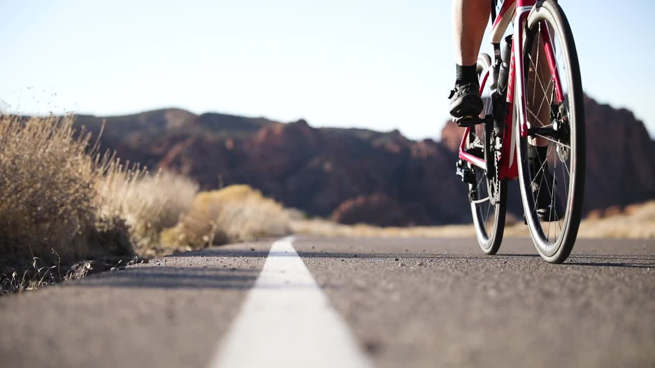 Premium stock video - Male cyclist on road bike on path in southwest ...