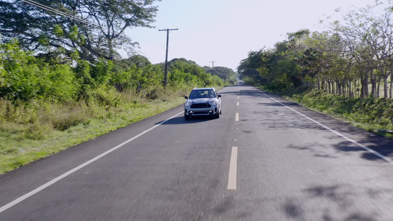 Premium stock video - Mini cooper driving in the road at daytime