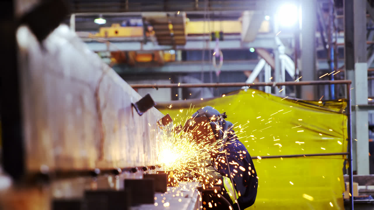 Premium stock video - Male engineer using welding torch 4k