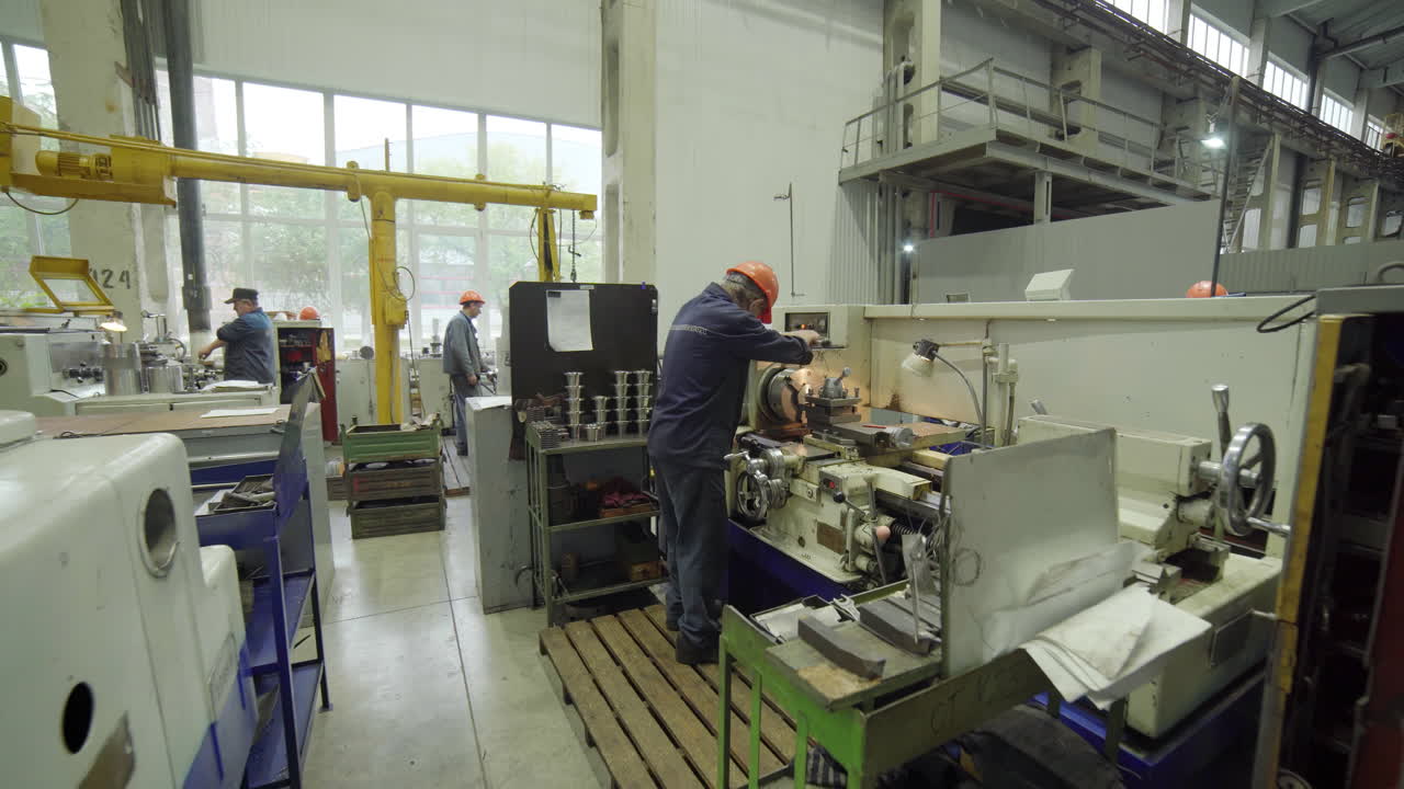 Factory workers operating lathes Premium Stock Video Footage