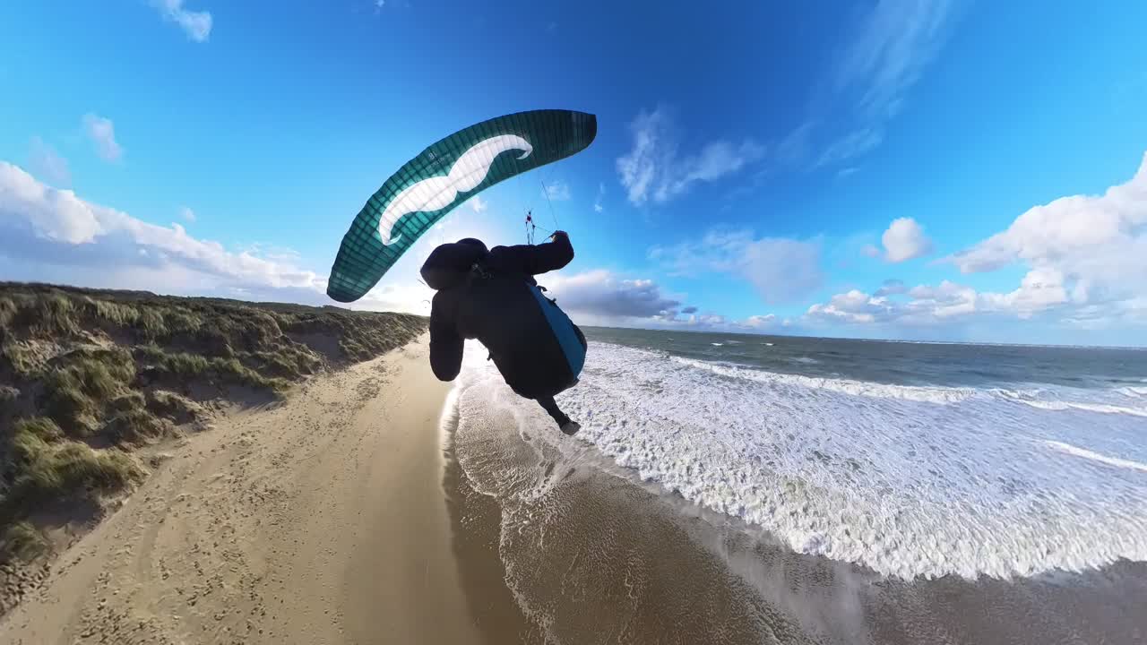 Premium stock video - Paraglider speed soaring along coastline over ...