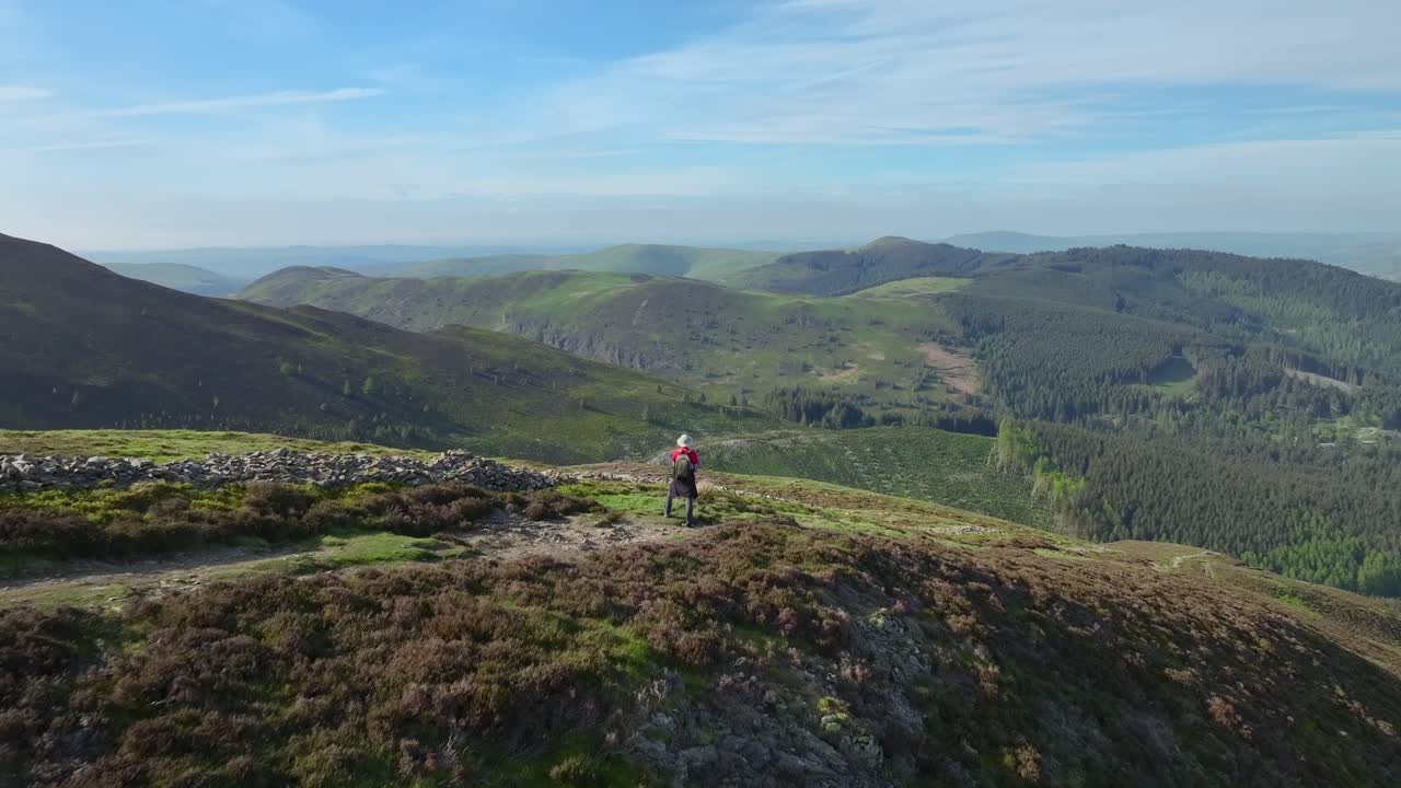 Premium stock video - Mountain walker on high path with flyover ...