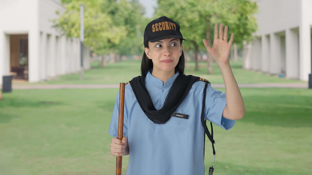Premium stock video - Happy indian female security guard giving ...