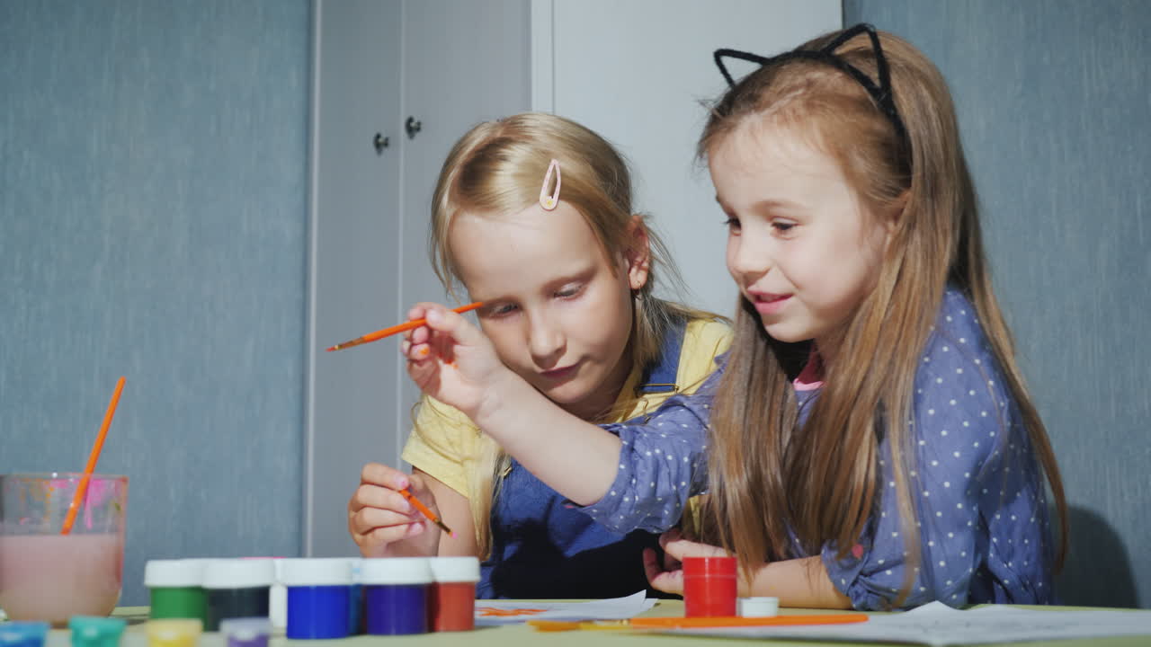 Children have fun together - paint with water colors 4k video Premium ...