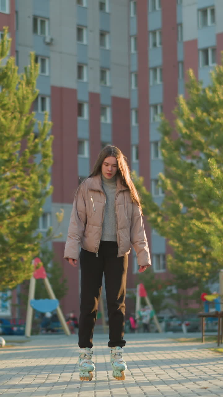 A young woman wearing a peach jacket and black trousers is ...