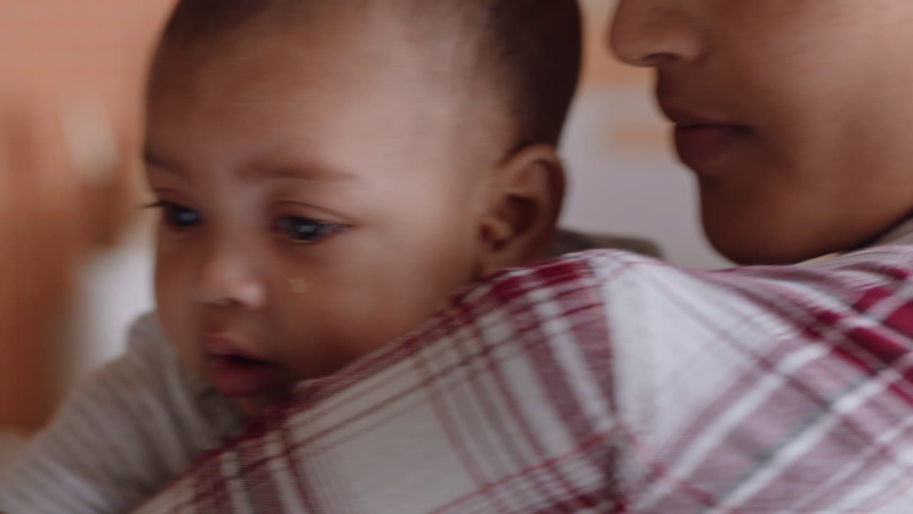 Premium stock video - Unhappy baby crying on mothers shoulder upset ...