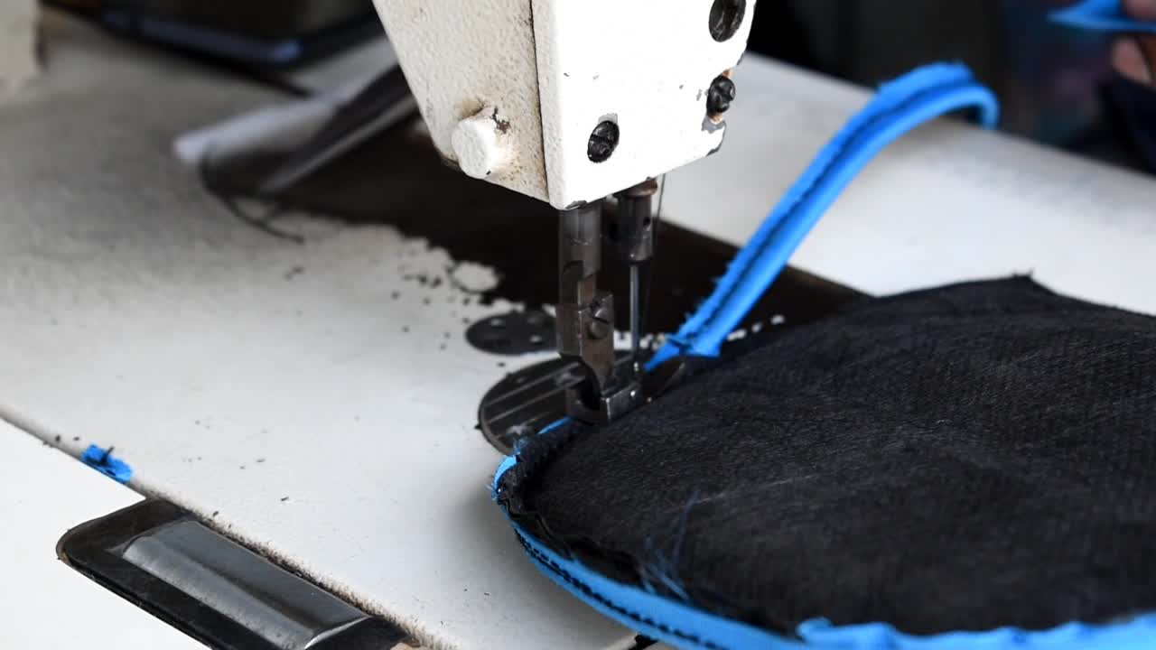 Tailor's Hands Stitching Edges Of Bag Padding With A Sewing Machine ...