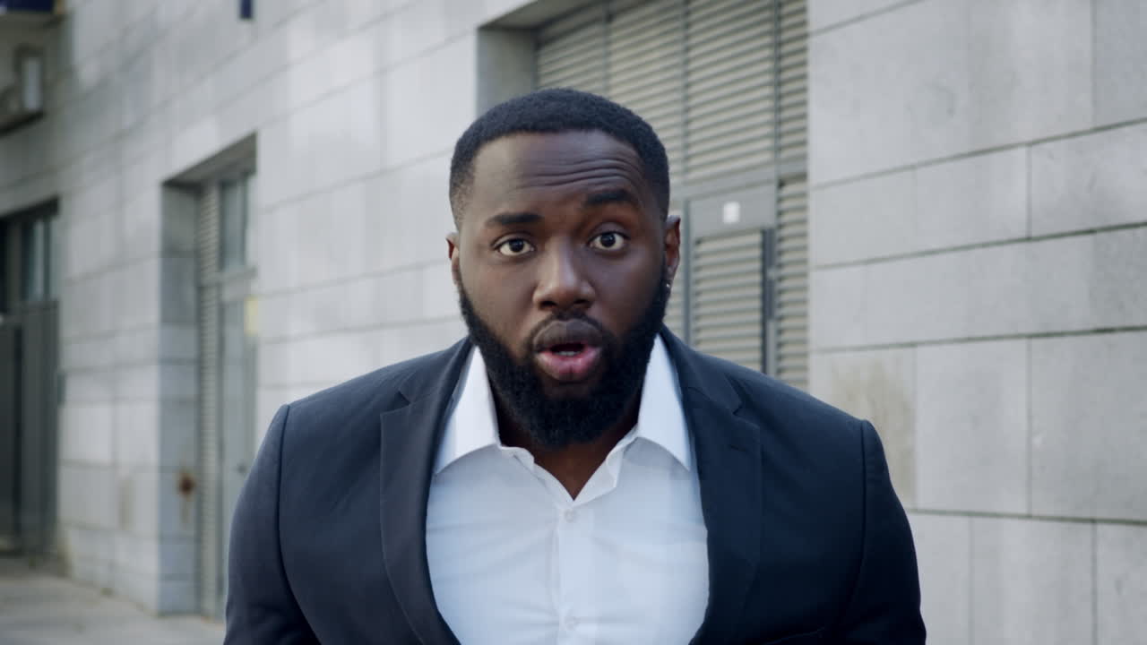 Premium stock video - Businessman talking online at camera on street ...