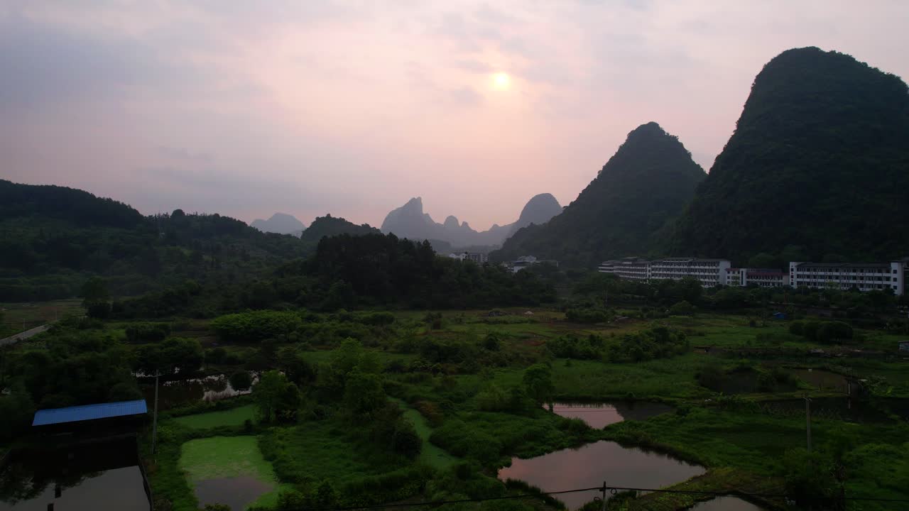 Sun reflects in water as drone fly towards the mountains of guilin at ...