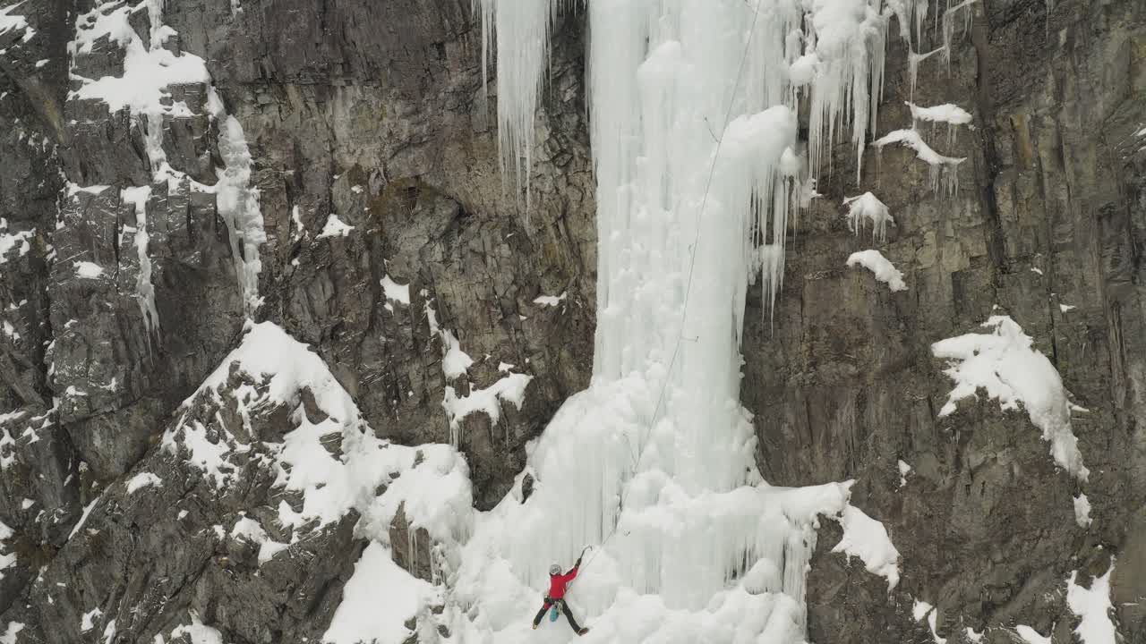 Breathtaking Aerial View Of Ice Climber Scaling Frozen Cascade Mount ...