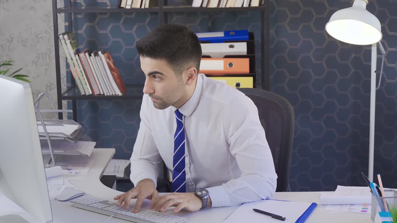 Premium stock video - Office worker man looking at his watch working in ...