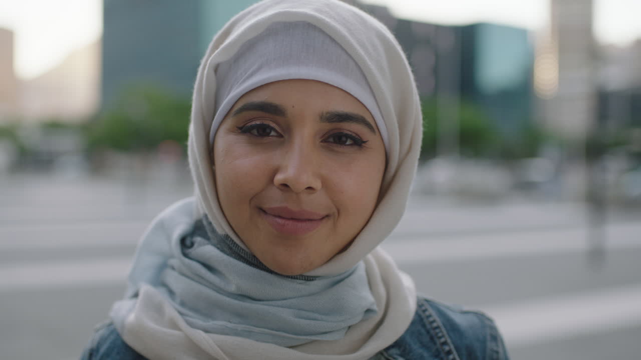 Portrait of young independent muslim woman looking confident at camera ...